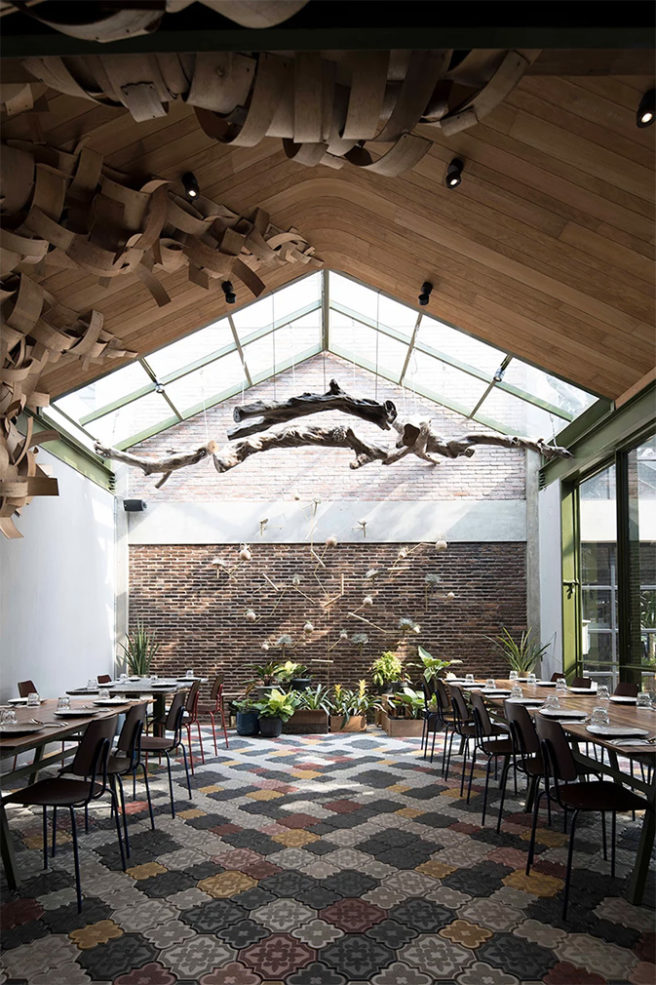 Tropical plants grow inside this jungle-themed restaurant just outside ...