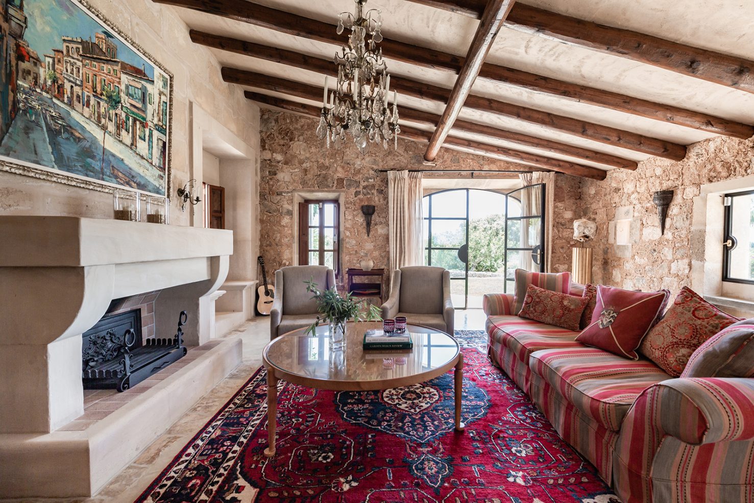 Lush gardens wrap around this rustic Mallorcan Finca in Santayi
