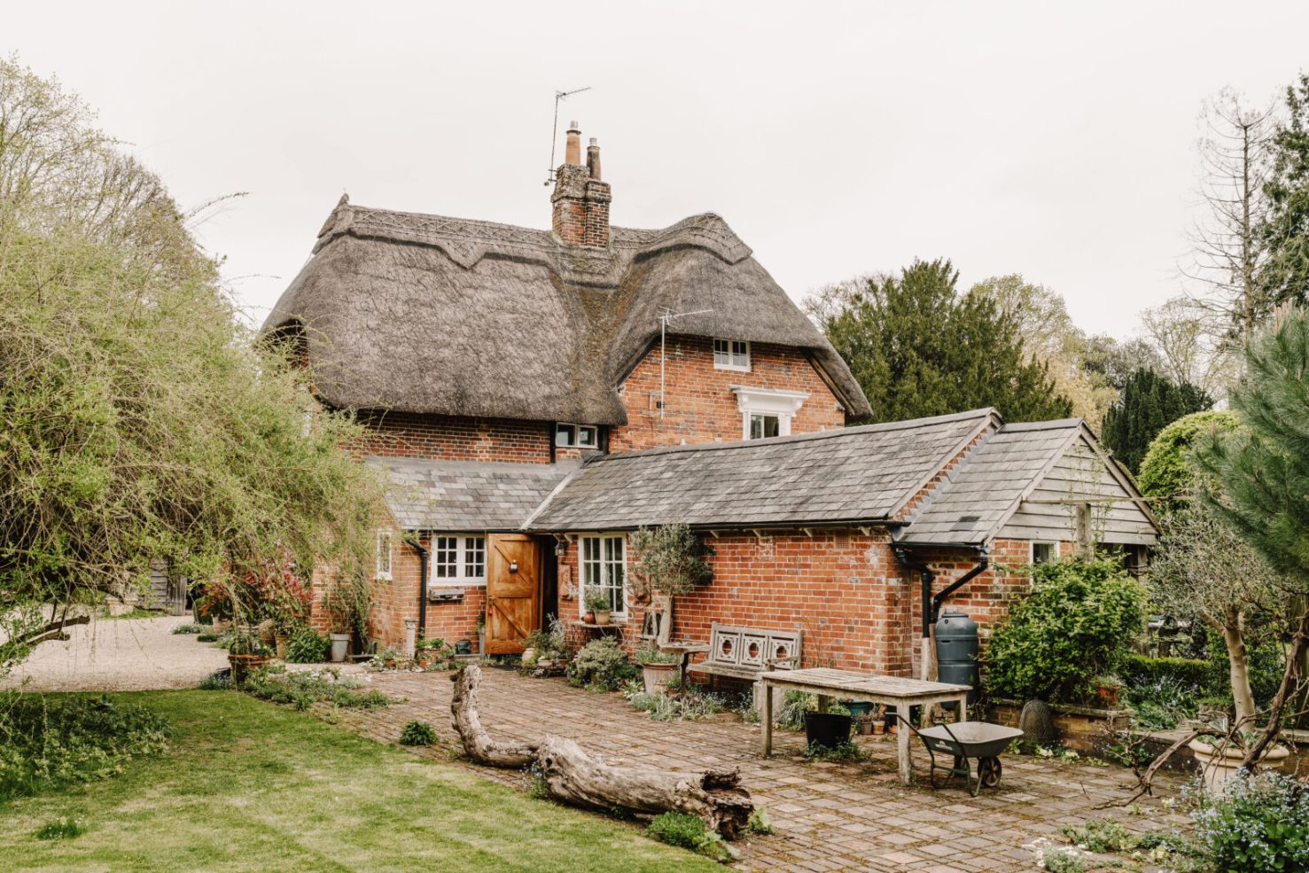 A country cottage beckons from beneath an enchanting thatched roof ...