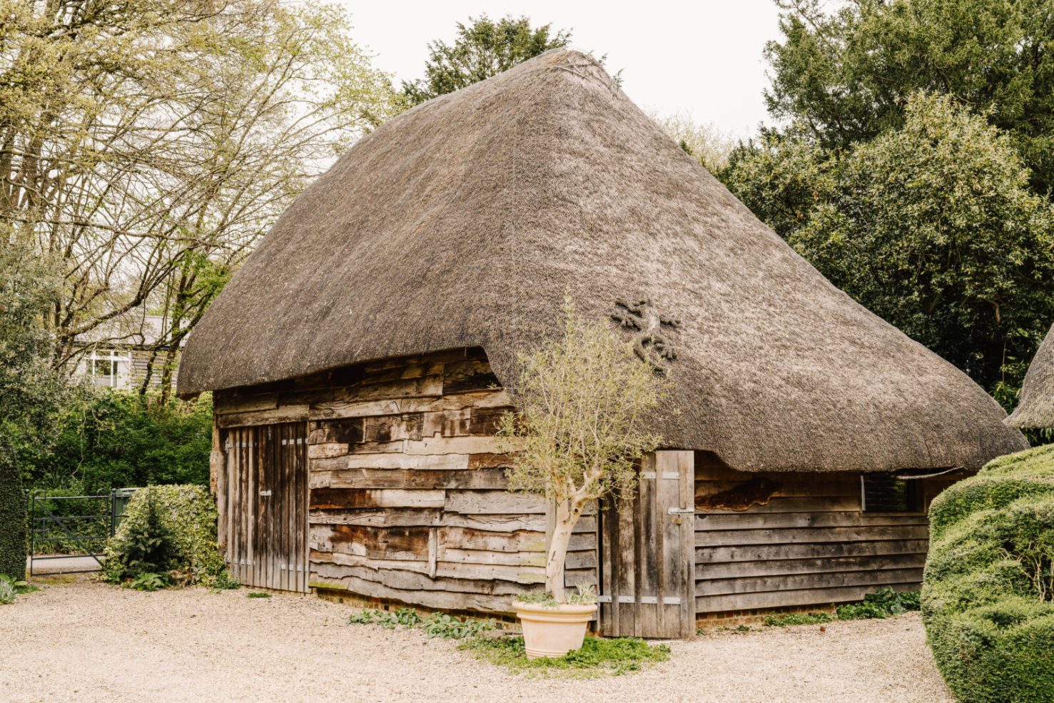 A country cottage beckons from beneath an enchanting thatched roof ...