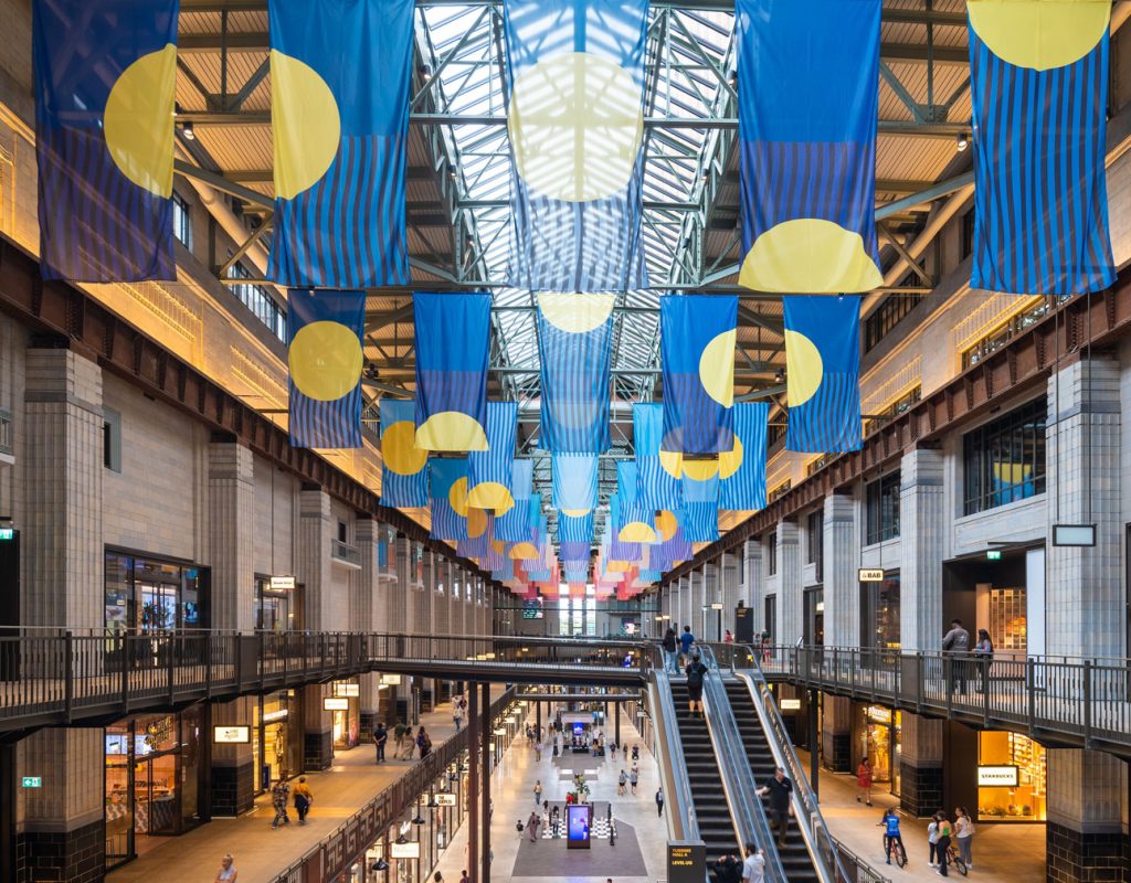 Colourful banners chart the sun inside Battersea Power Station this ...
