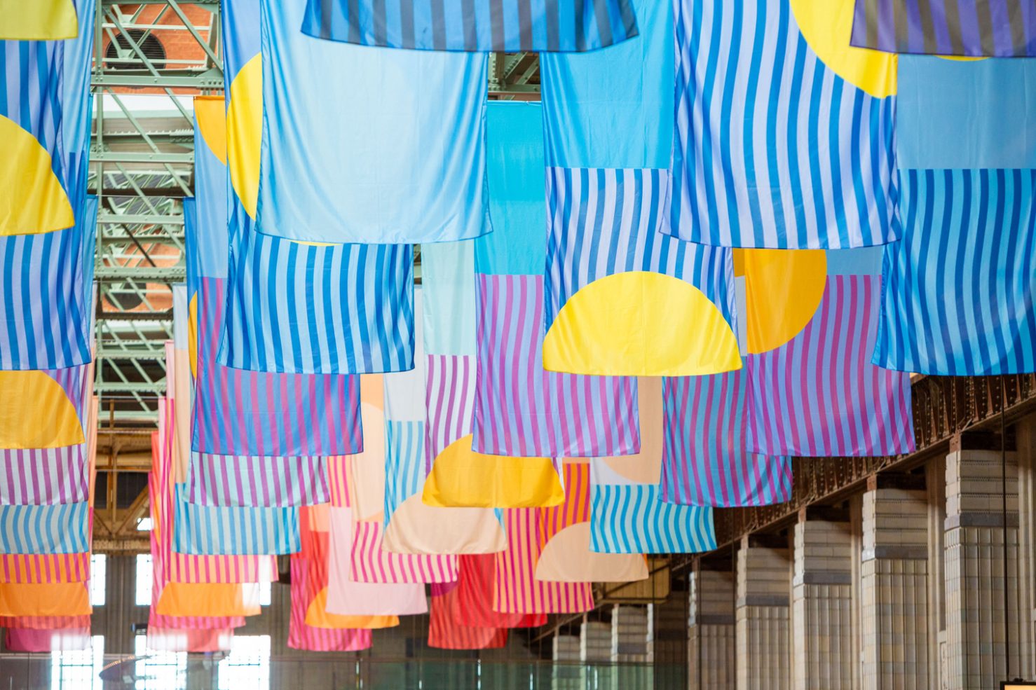 Colourful banners chart the sun inside Battersea Power Station this ...